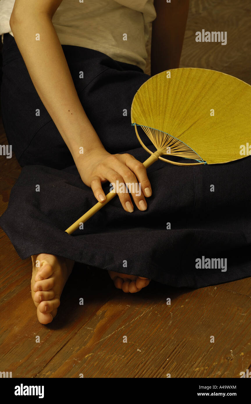 Low section view of a woman holding a fan Stock Photo - Alamy
