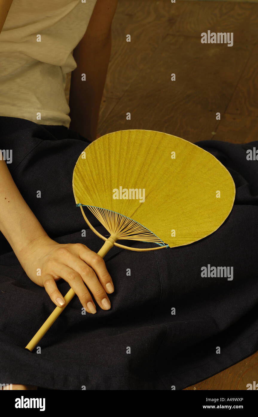 Low section view of a woman holding a fan Stock Photo - Alamy