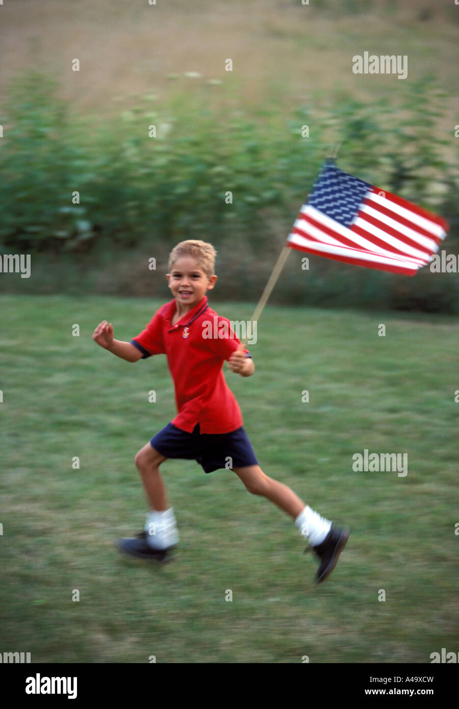 boy running with american flag, USA Stock Photo - Alamy