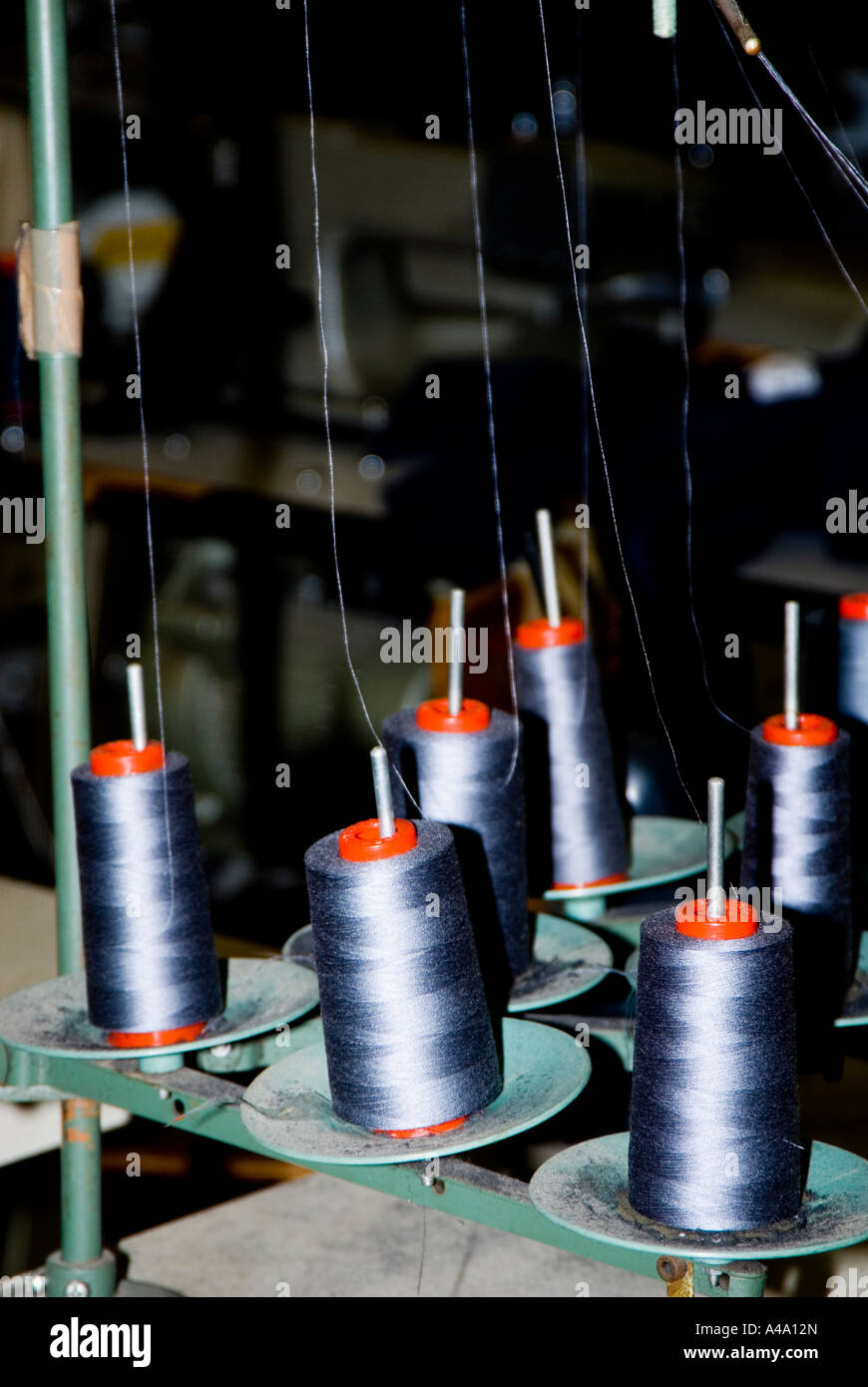 Close up of threads on a sewing machine in a factory in Manchester UK ...