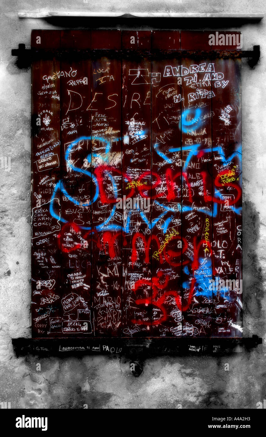 Graffiti on the shutters of a window in Sicily Italy Stock Photo - Alamy