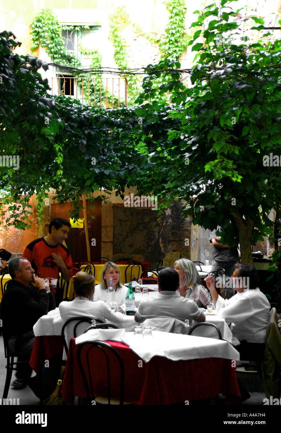 Diners at an open air restaurant on the Island of Ortygia Syracuse ...