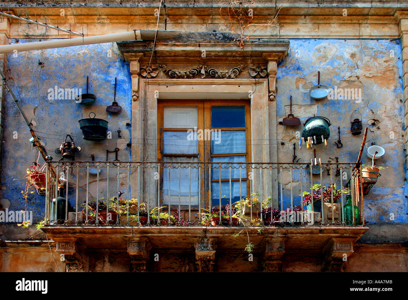 Eccentric pots and pans decoration on the window and balcony of a ...