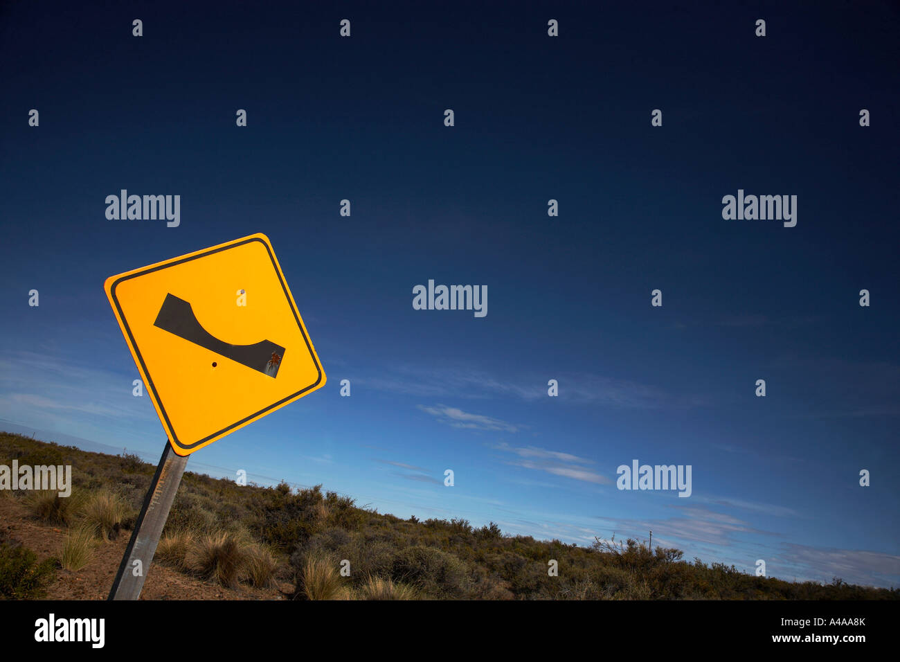 dip in road sign patagonia Stock Photo - Alamy