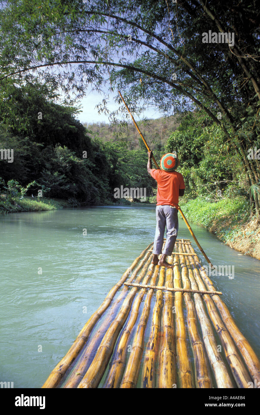 Man rowing bamboo raft down the Martha Brae river in Jamaica Caribbean ...