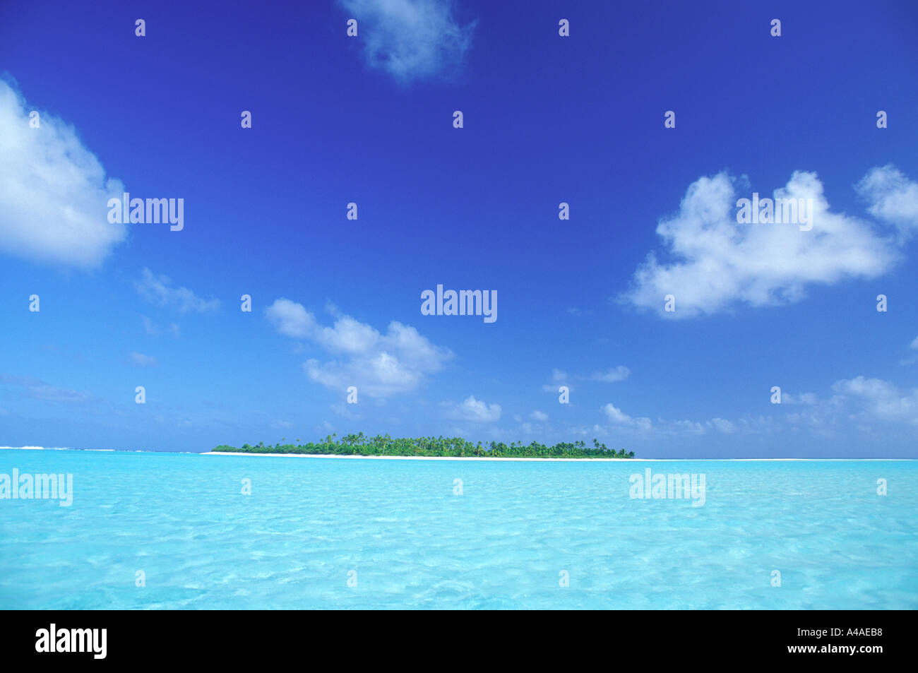 View of tropical island in the distance with shallow water in ...