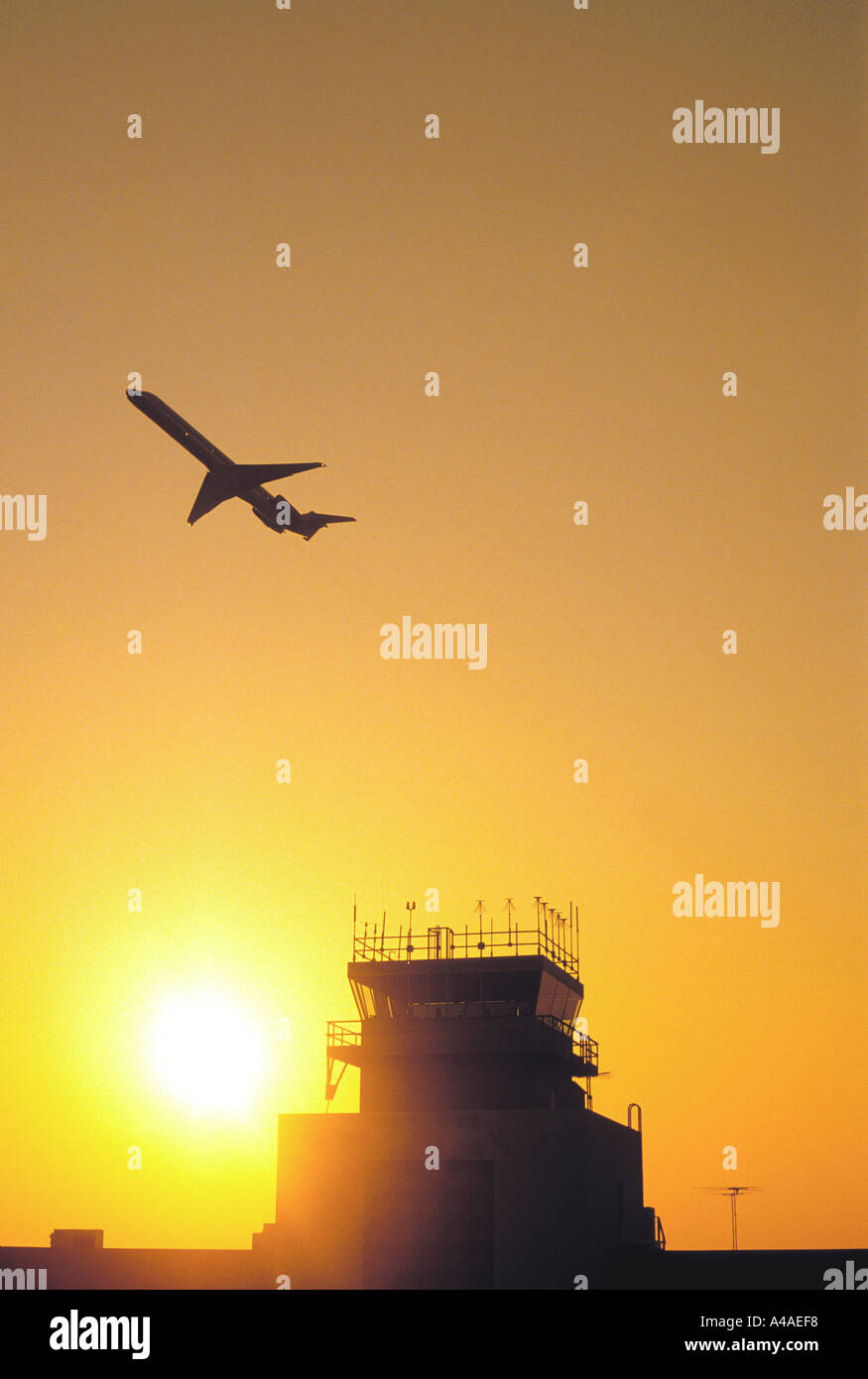 Airport control tower with airplane taking off Stock Photo - Alamy