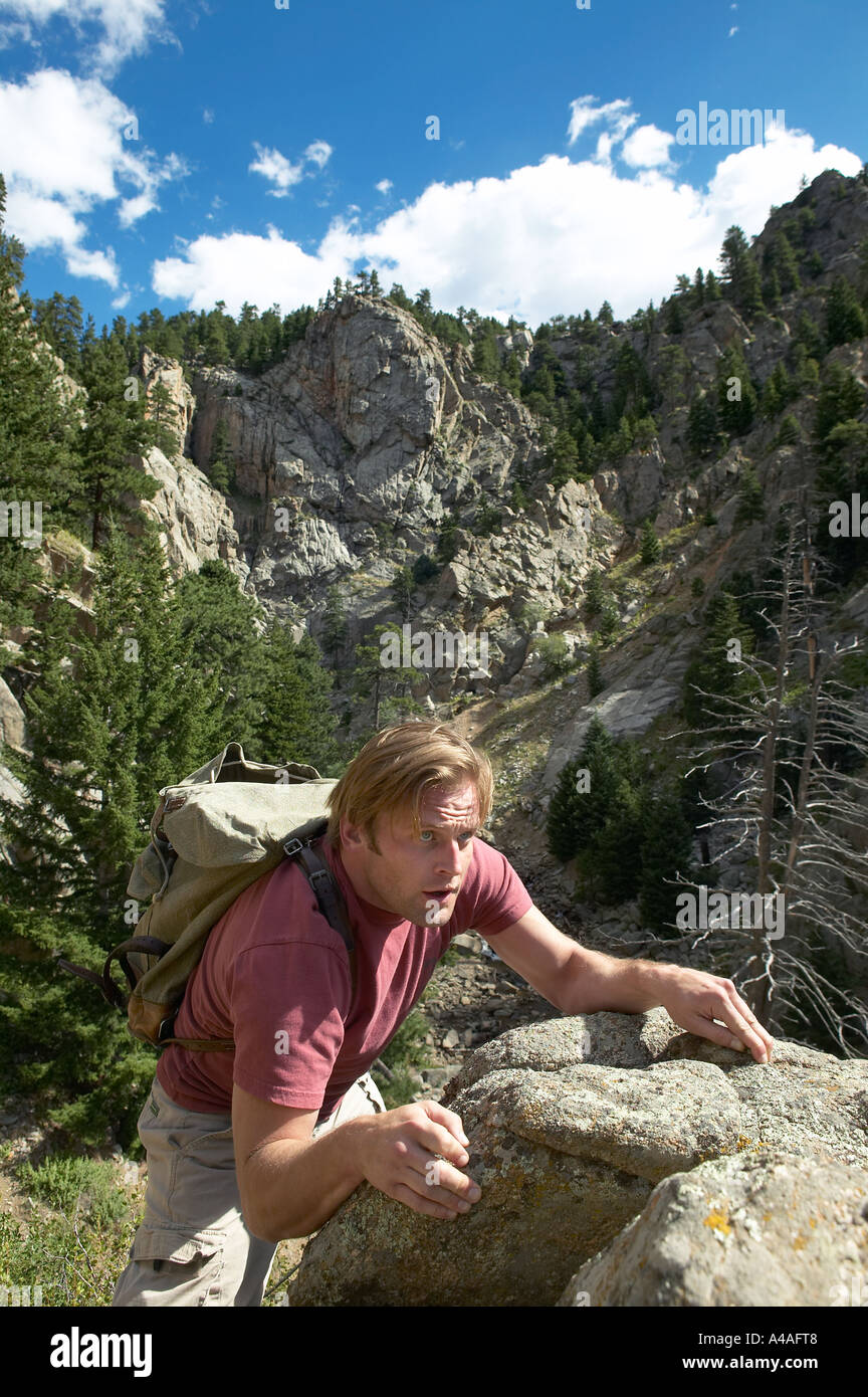 Caucasian male climbing over rock in Colorado mountains Stock Photo - Alamy
