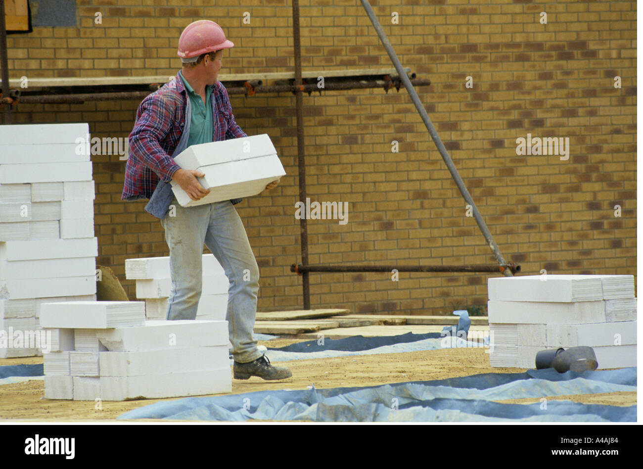 Construction worker carrying blocks hi-res stock photography and images ...