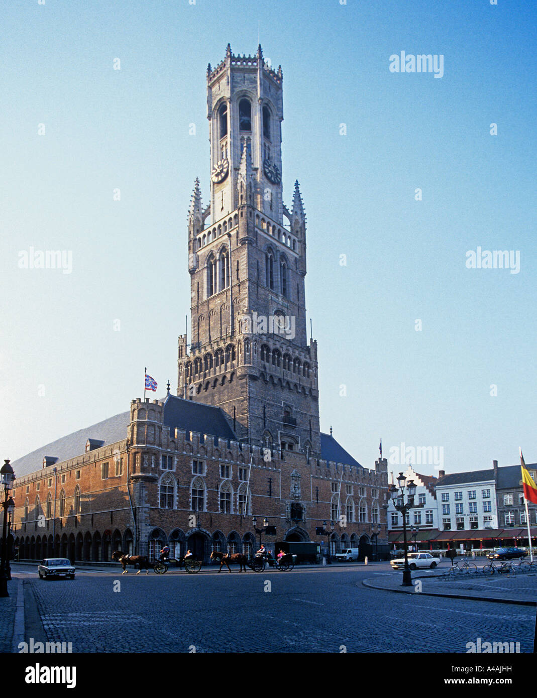 The ornate Halles Belfry towers above the cobbled central city Square ...