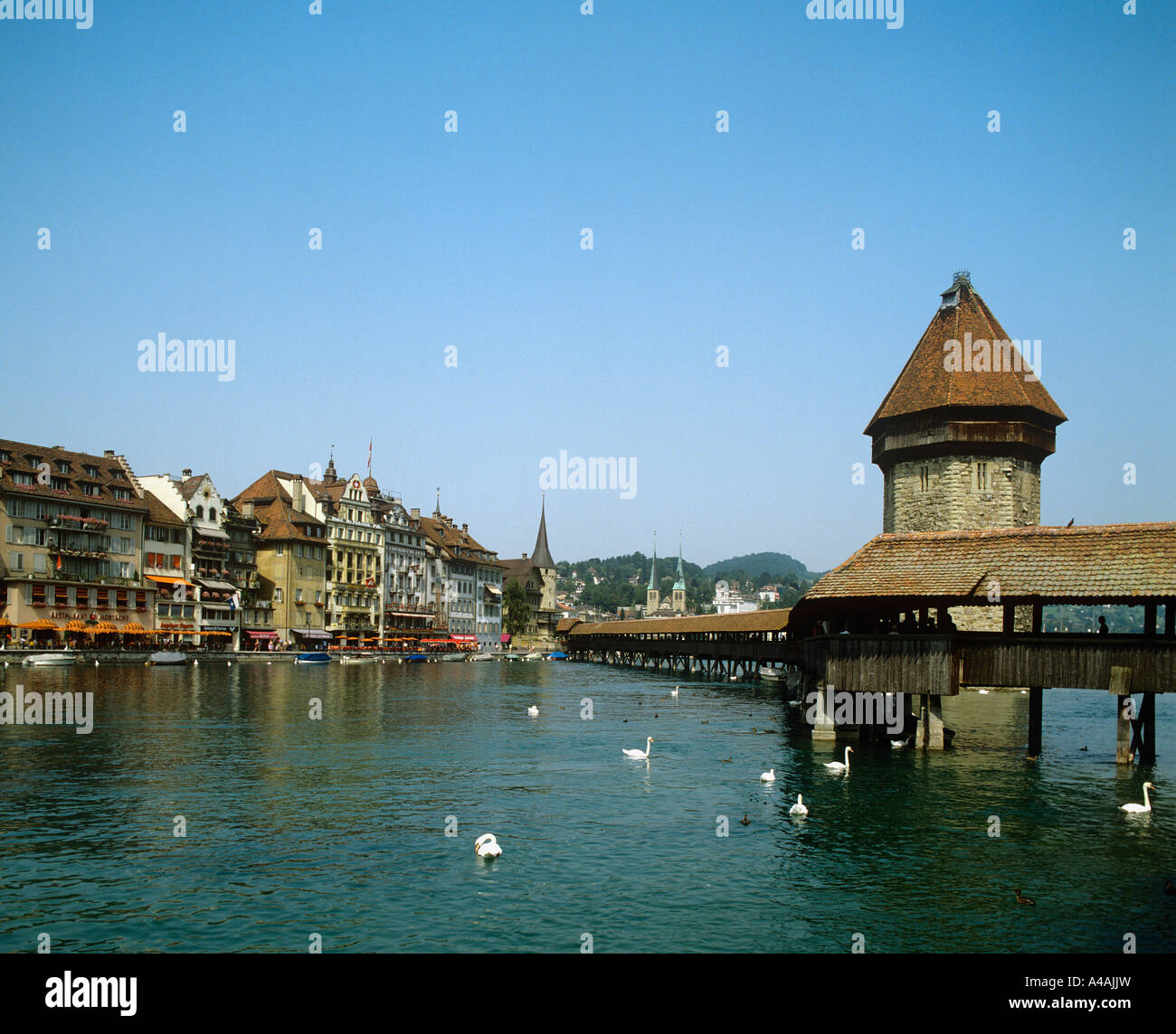 The long decorated wooden Chapel foot bridge across an inlet of Lake ...