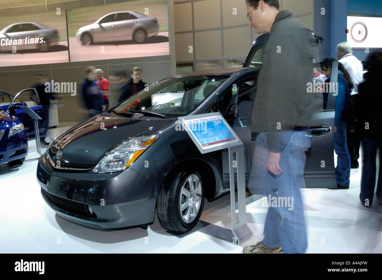 Man looking at a Toyota Prius on display at the North American ...