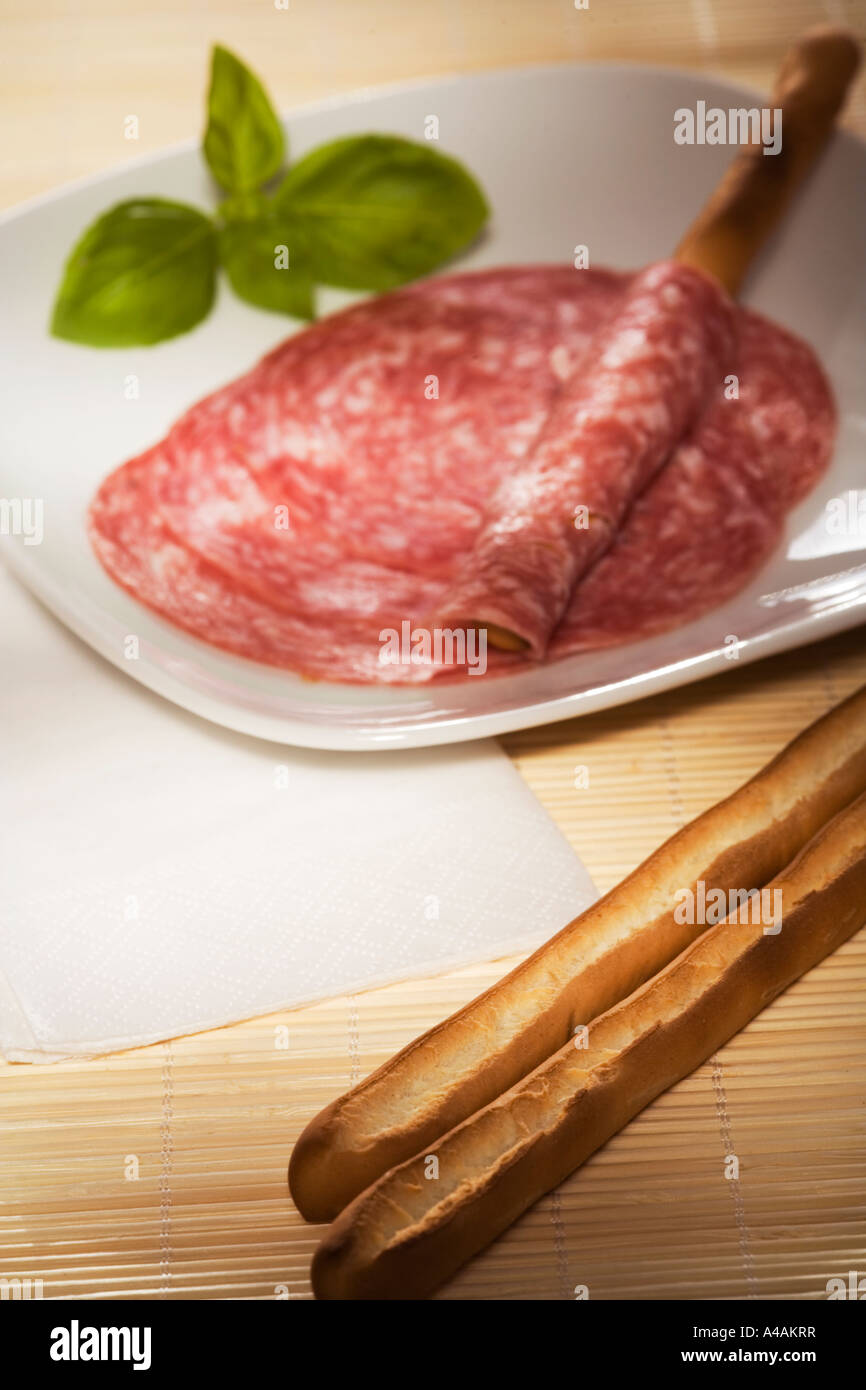 Salami meat snack with breadsticks Stock Photo - Alamy