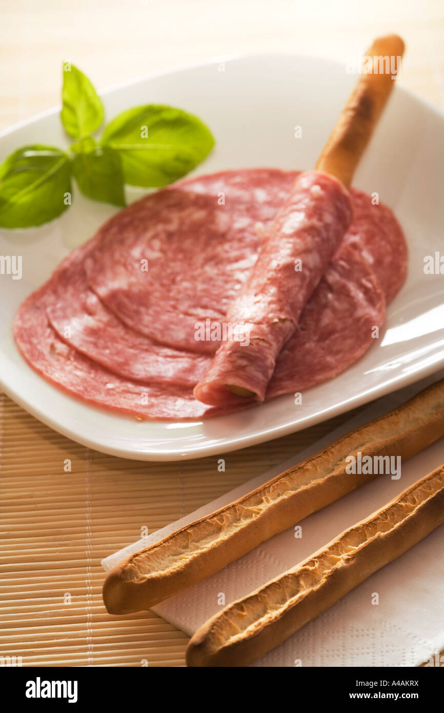 Salami meat snack with breadsticks Stock Photo - Alamy