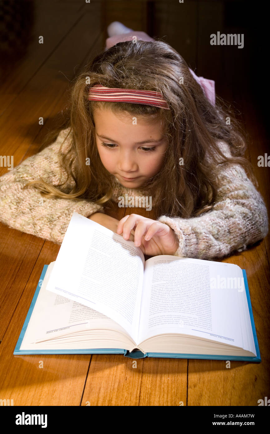 Attentive little reader Stock Photo - Alamy