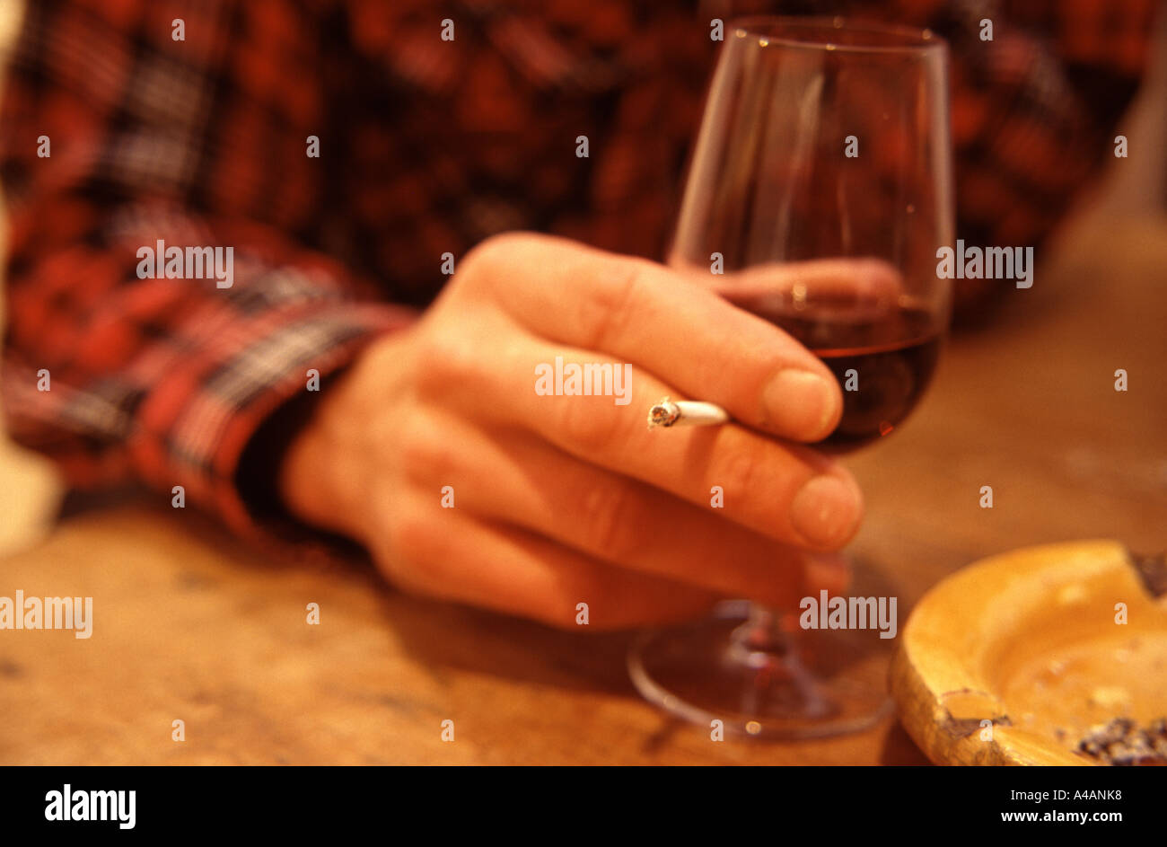 Man smoking and drinking red wine in pub Stock Photo - Alamy