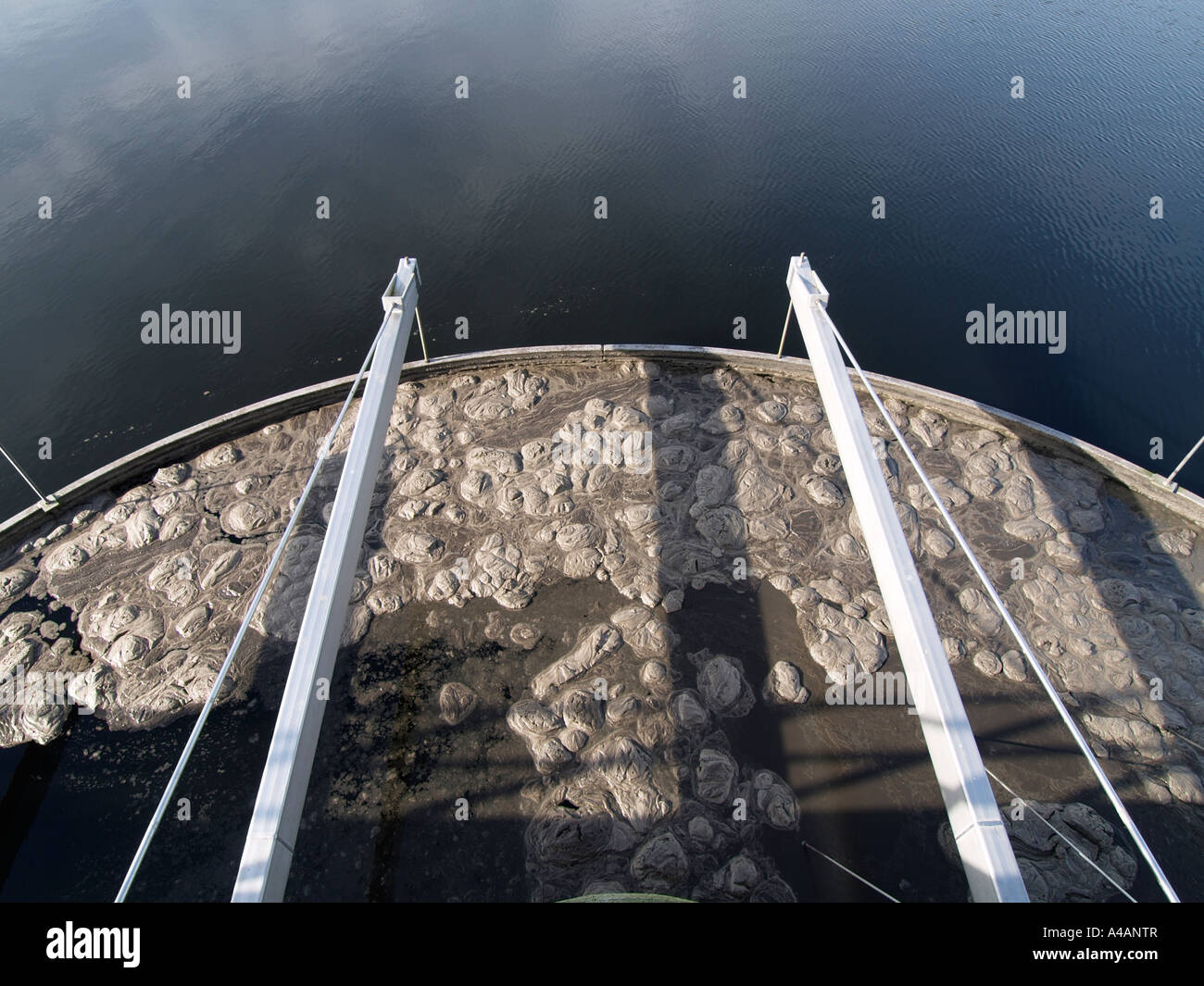 Floating silt ooze mire slime mud being contained and removed in a ...