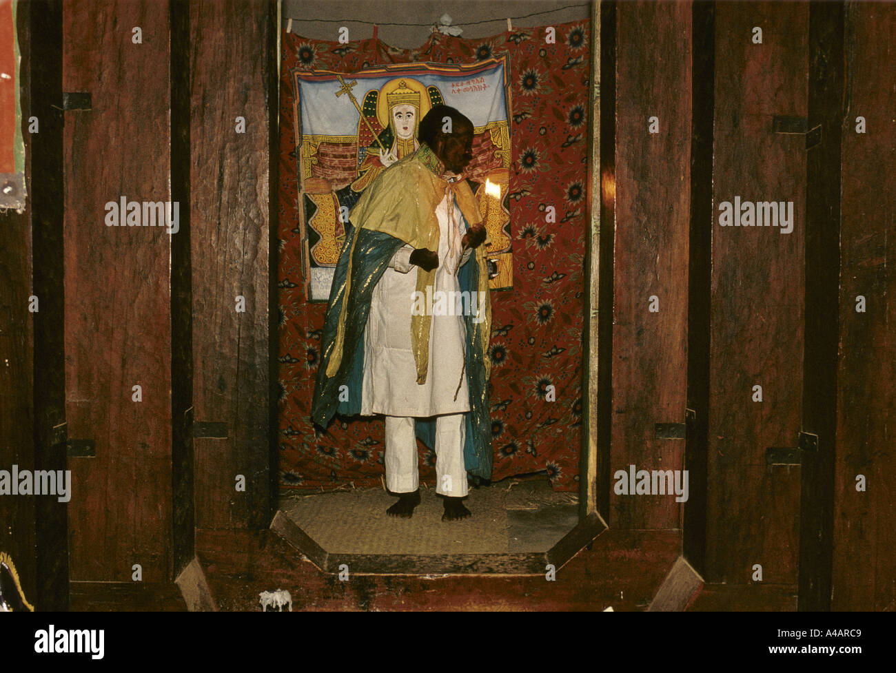 MAN STANDING IN FRONT OF CHRISTIAN, RELIGIOUS WALL HANGING, IN THE ...