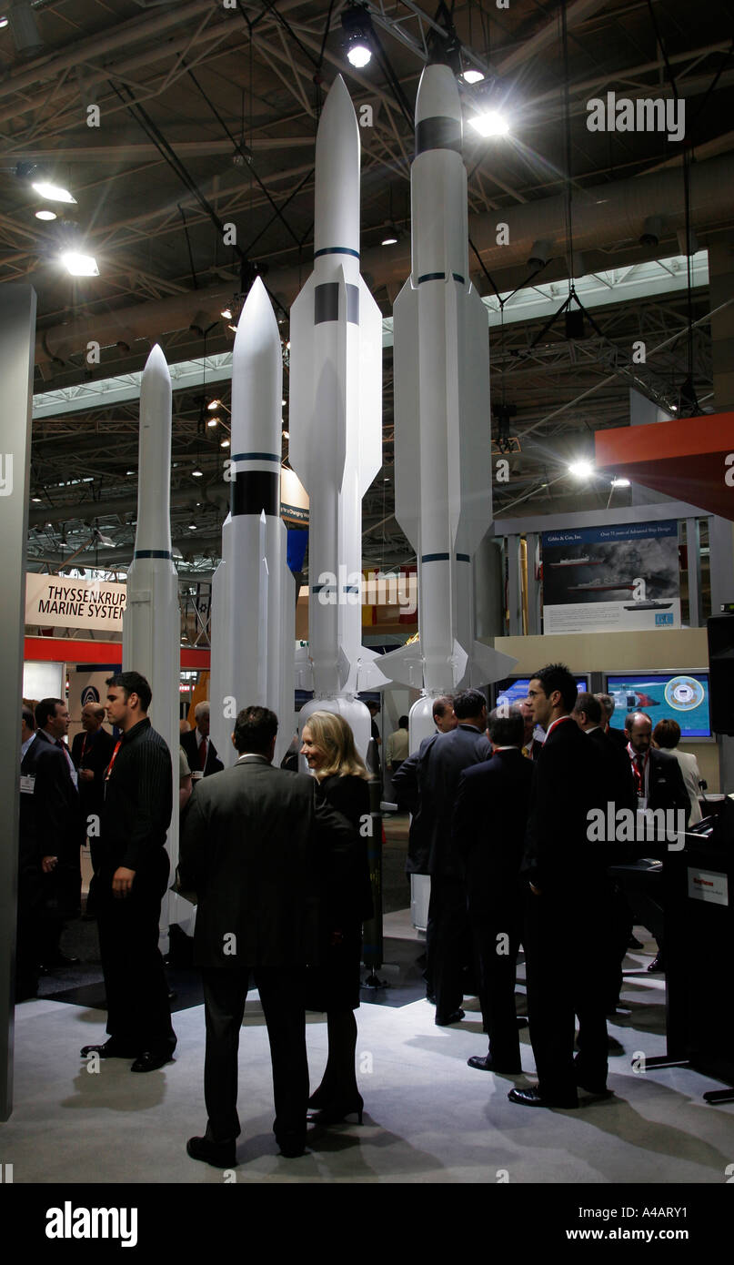 Defense personnel inspect weapons systems at a defence trade fair in ...