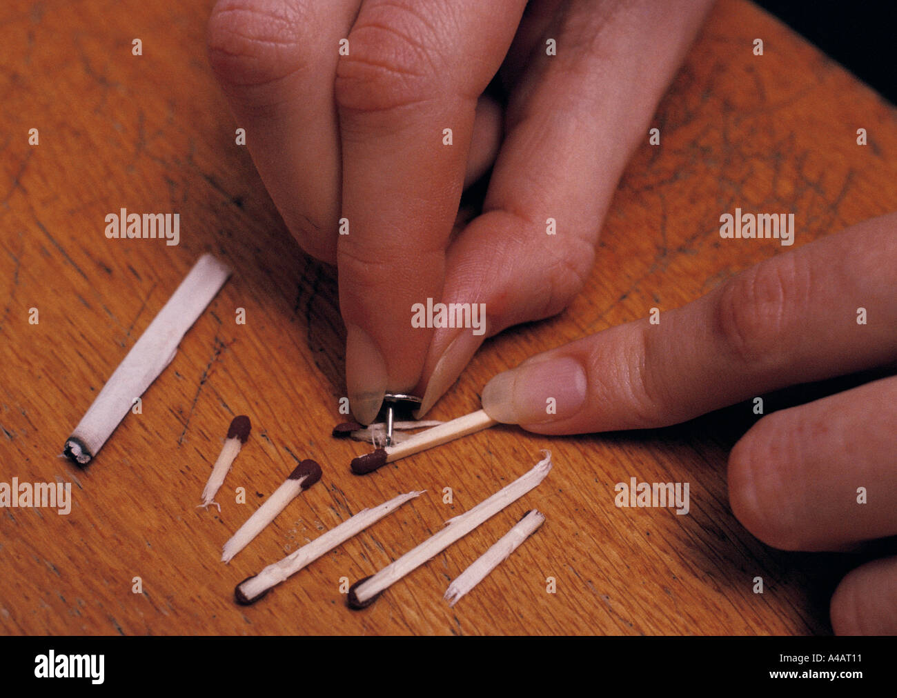 A close-up view of a prisoner splitting matches with a drawing pin ...