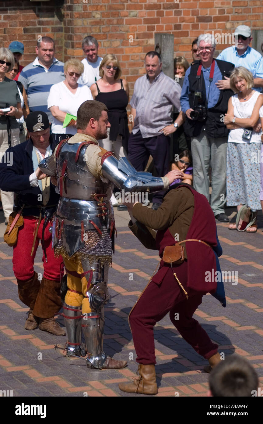A knight demonstrates to a crowd how he would have prepared for battle ...
