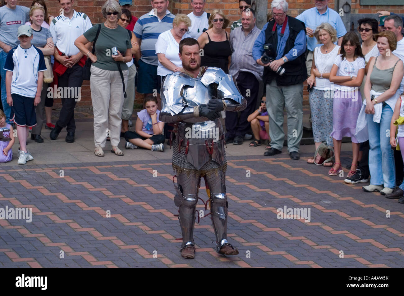 A knight demonstrates to a crowd how he would have prepared for battle ...
