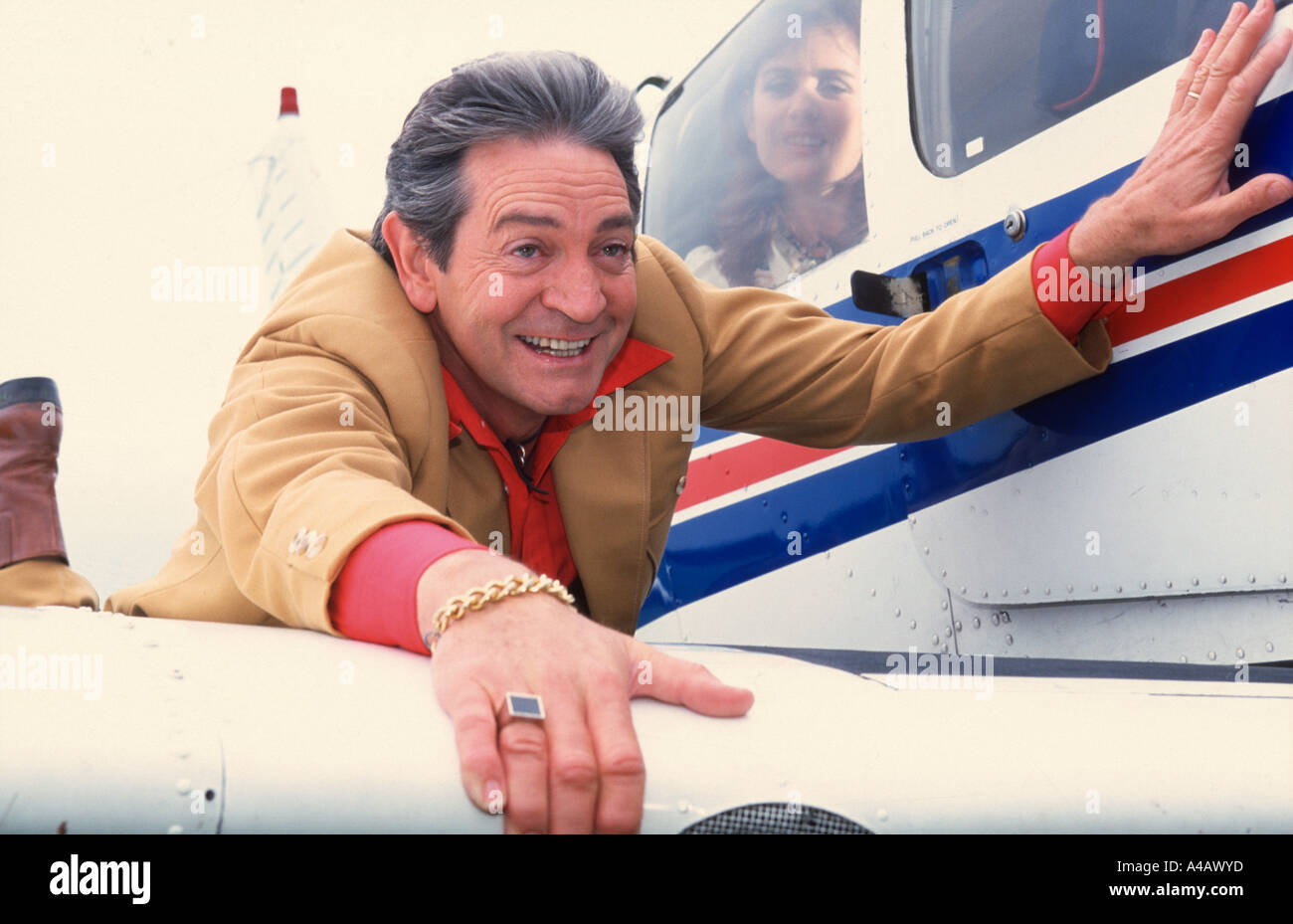 Actor Patrick Mower Emmerdales Rodney Blackstock hanging onto a light ...