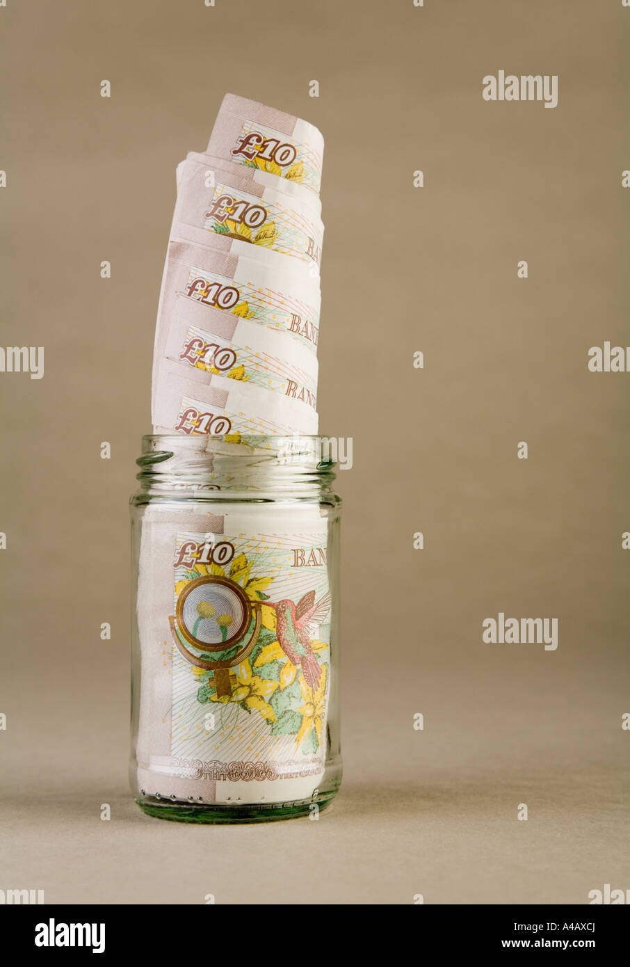 Pound notes in savings jar hi-res stock photography and images - Alamy