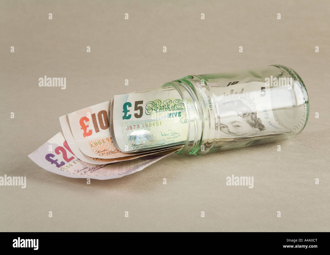 Pound notes in savings jar hi-res stock photography and images - Alamy