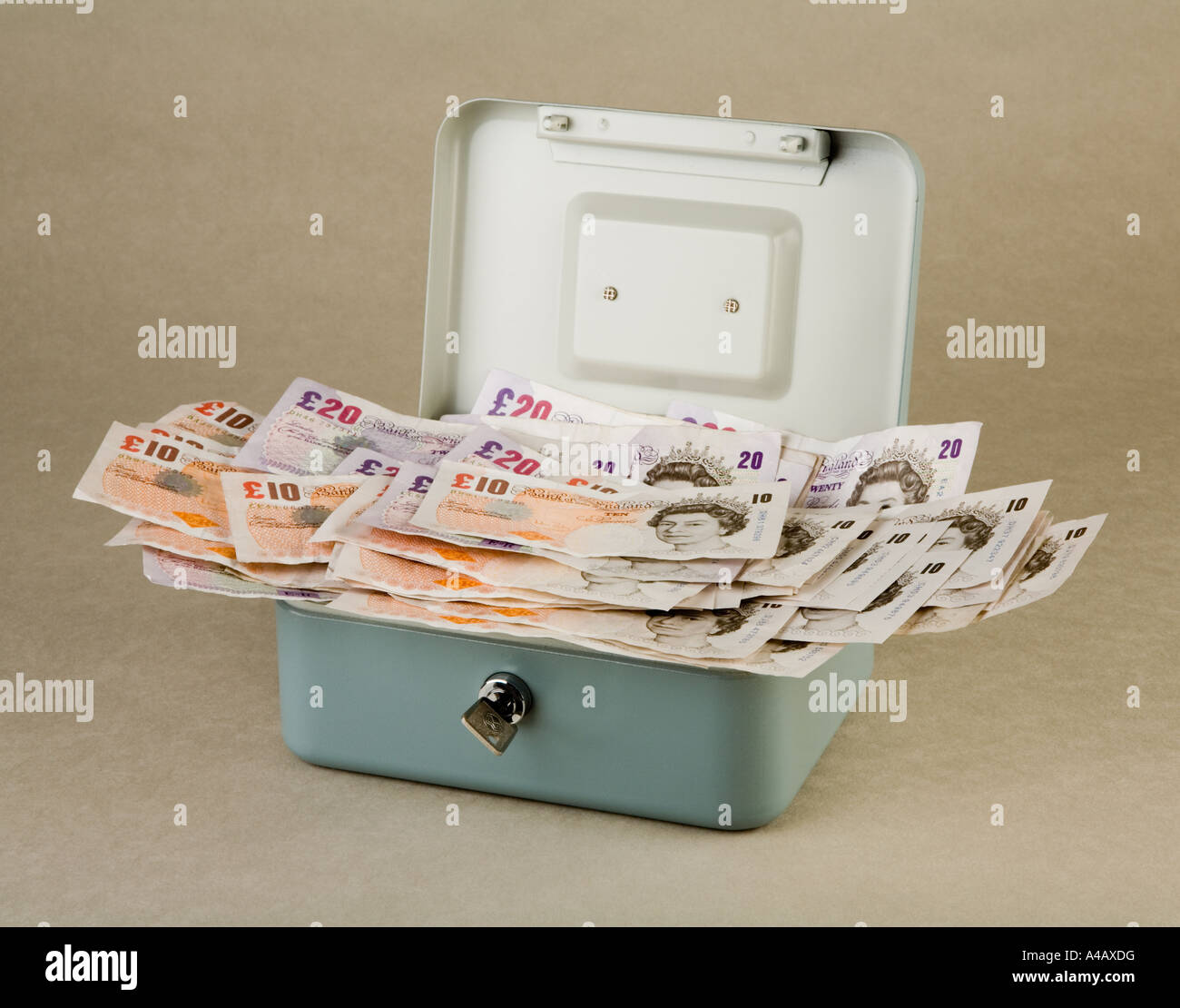 A cash tin full of used 10 and 20 pound bank notes Stock Photo - Alamy