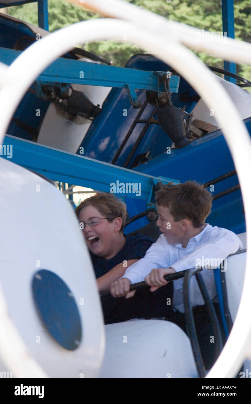 Boys Riding a ride at the carnival Stock Photo - Alamy