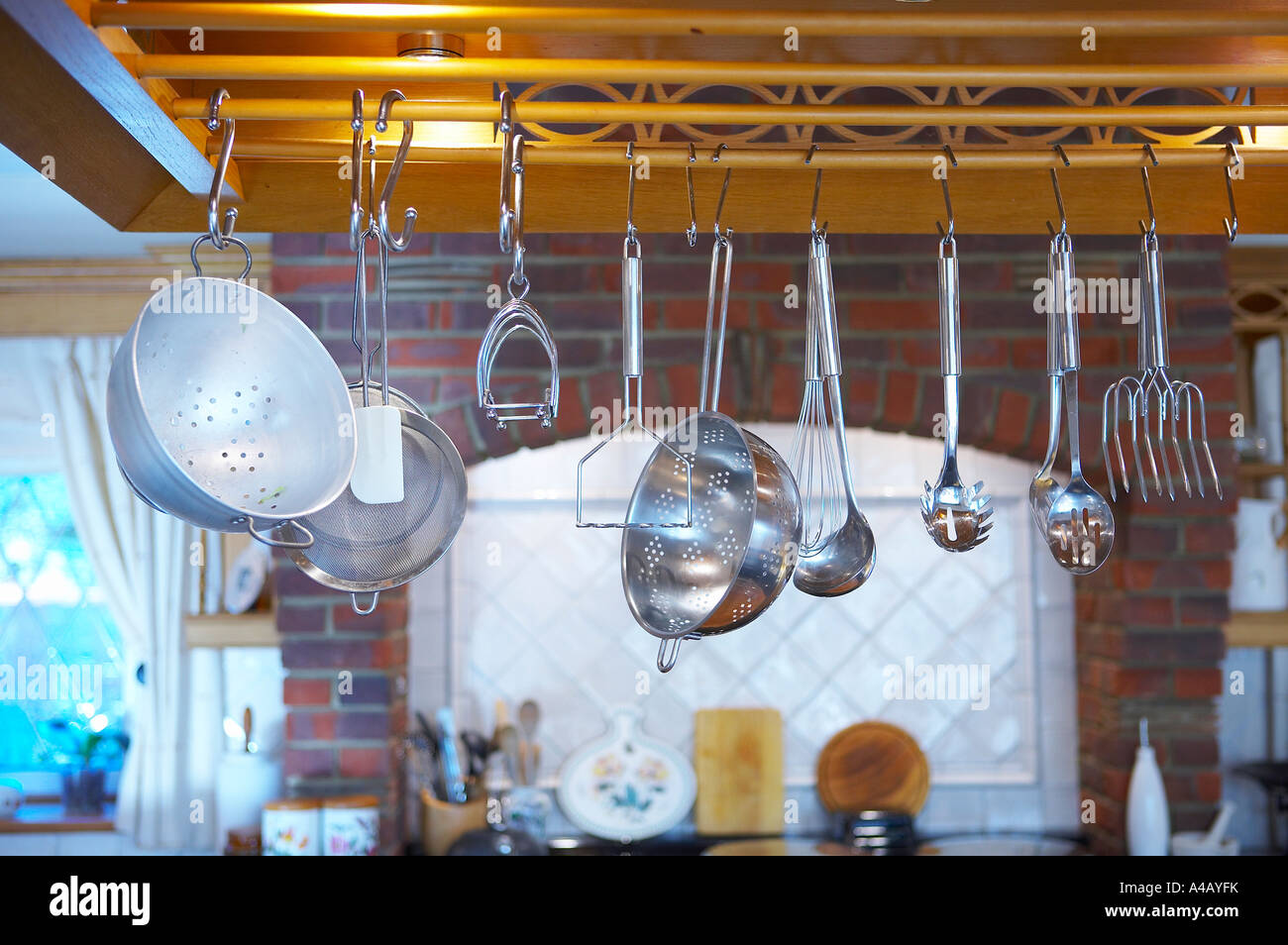 Cooking utensils hanging in a kitchen Stock Photo - Alamy