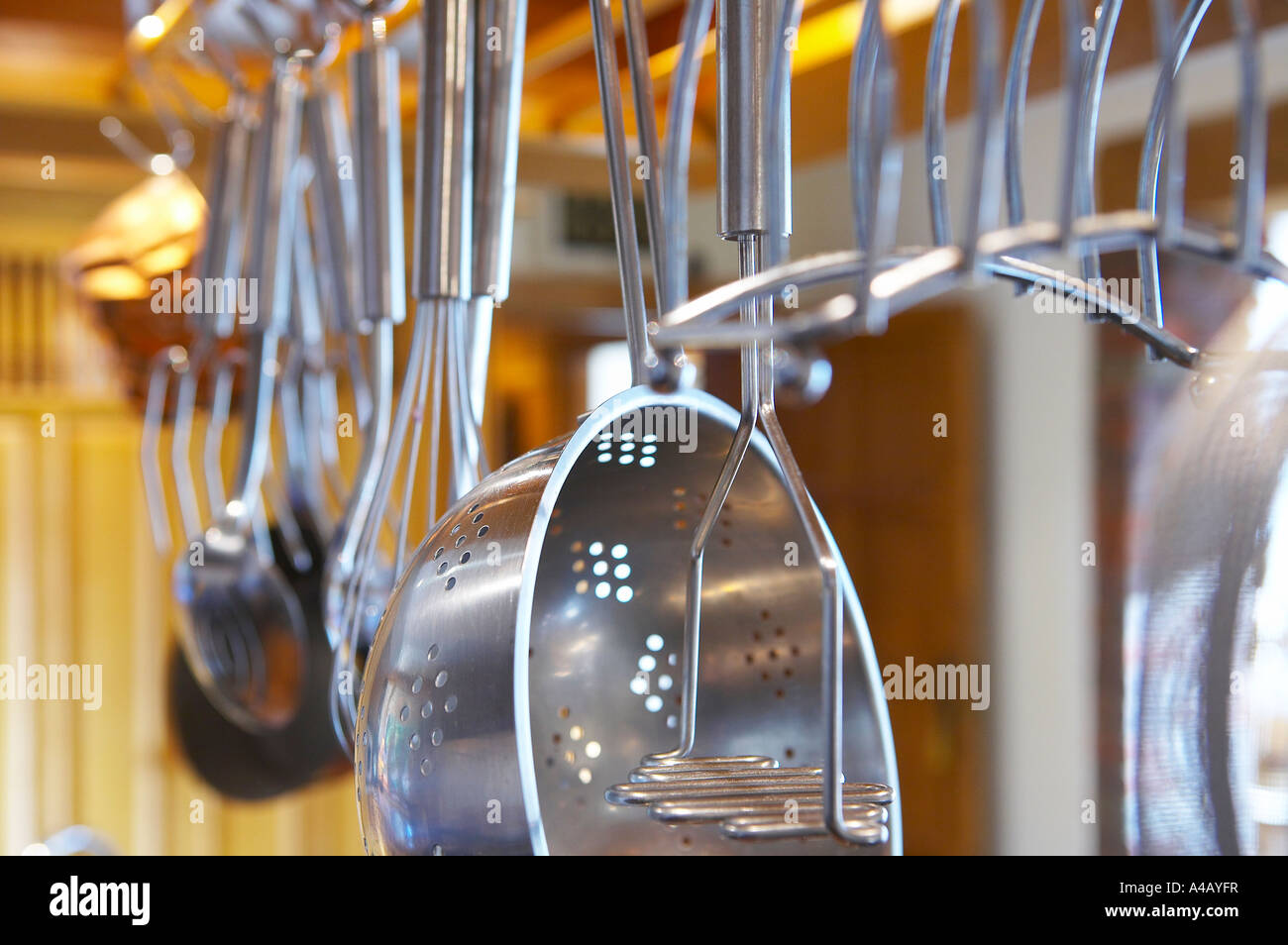 Cooking utensils hanging in a kitchen Stock Photo - Alamy
