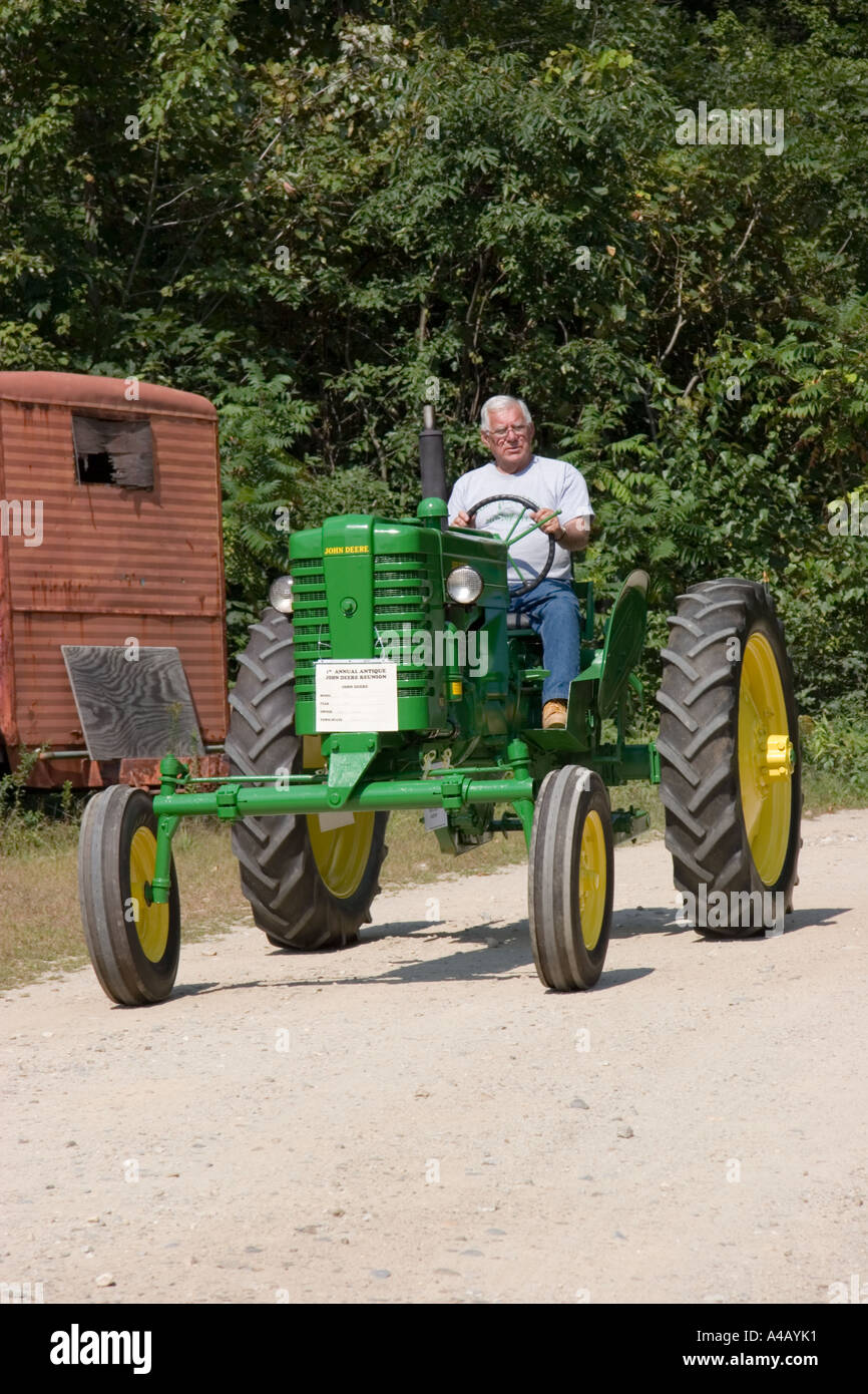 Man riding a John Deere tractor Stock Photo - Alamy
