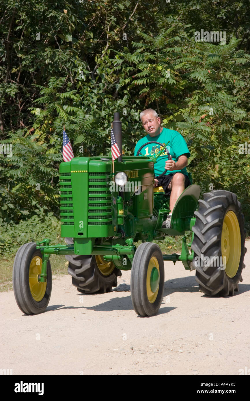 Man riding a John Deere tractor Stock Photo - Alamy