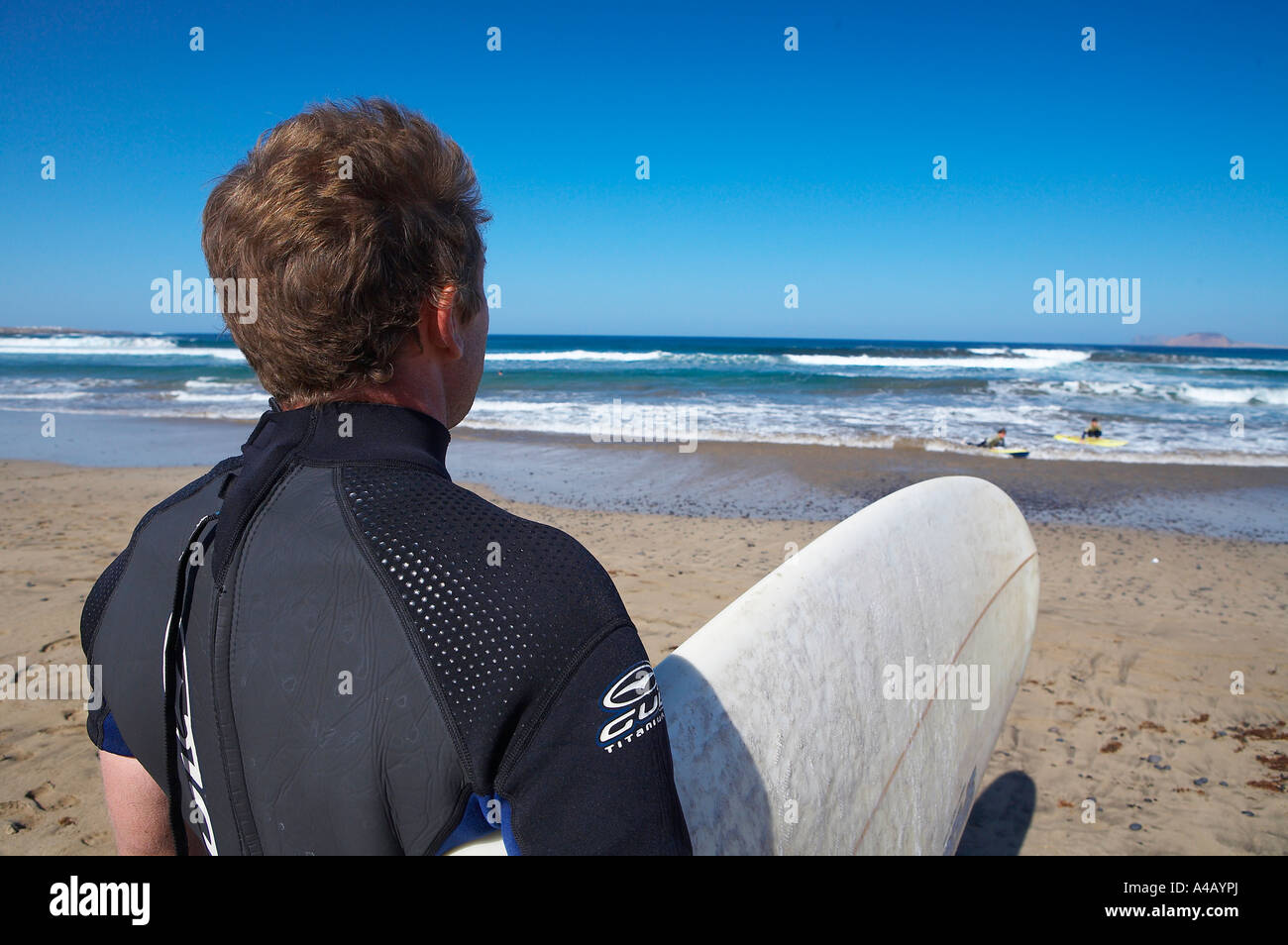 surfer watching the surf and looking out to sea Stock Photo - Alamy