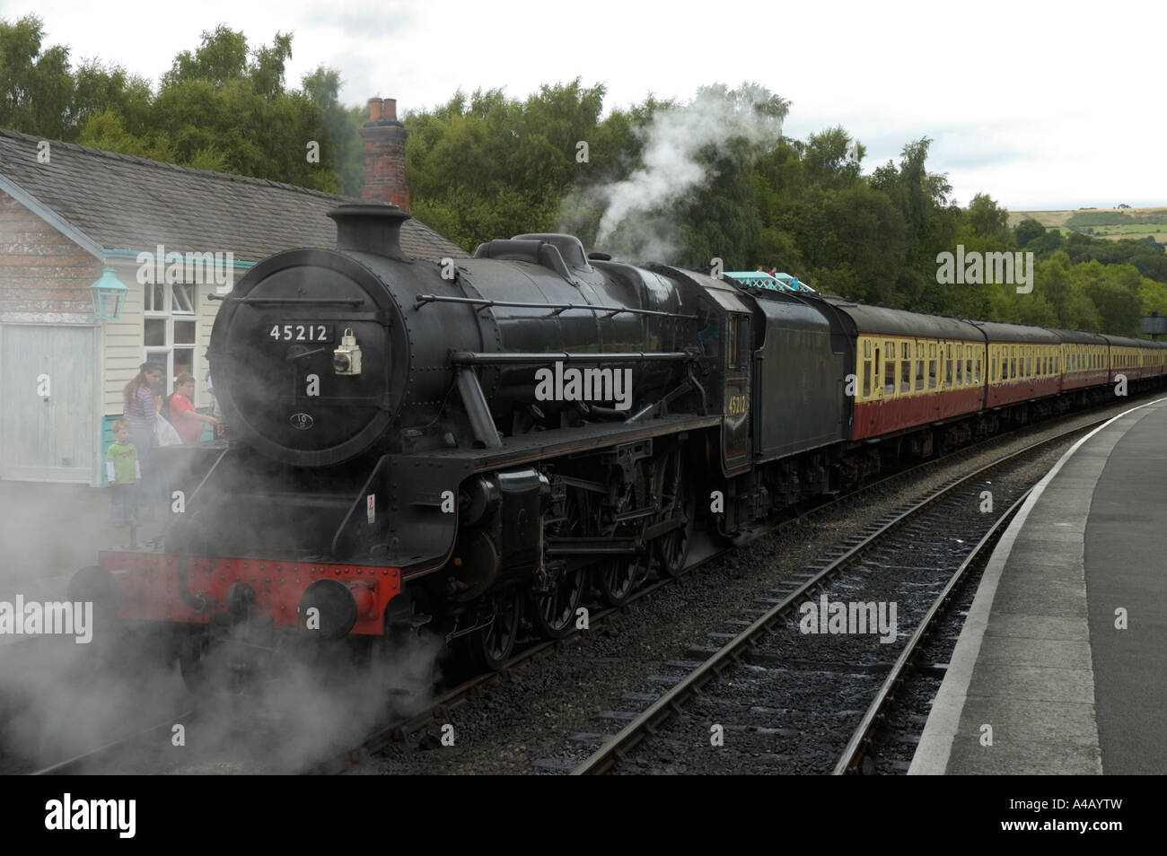 Steam engine train going through the Yorkshire Moors, departing from ...