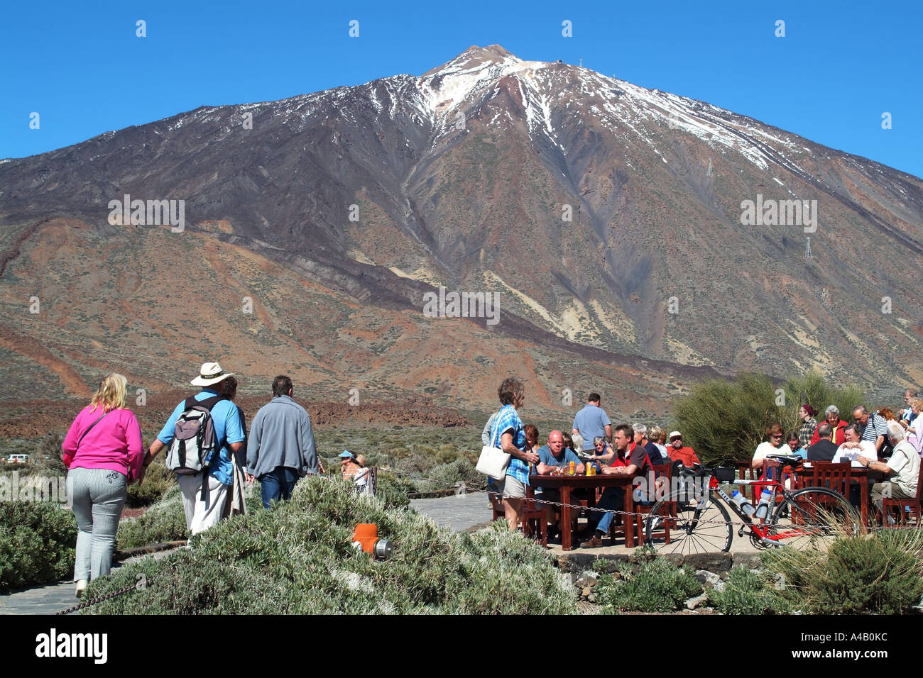 Tourists within site of Mount Teide enjoy a snack at the cafeteria ...