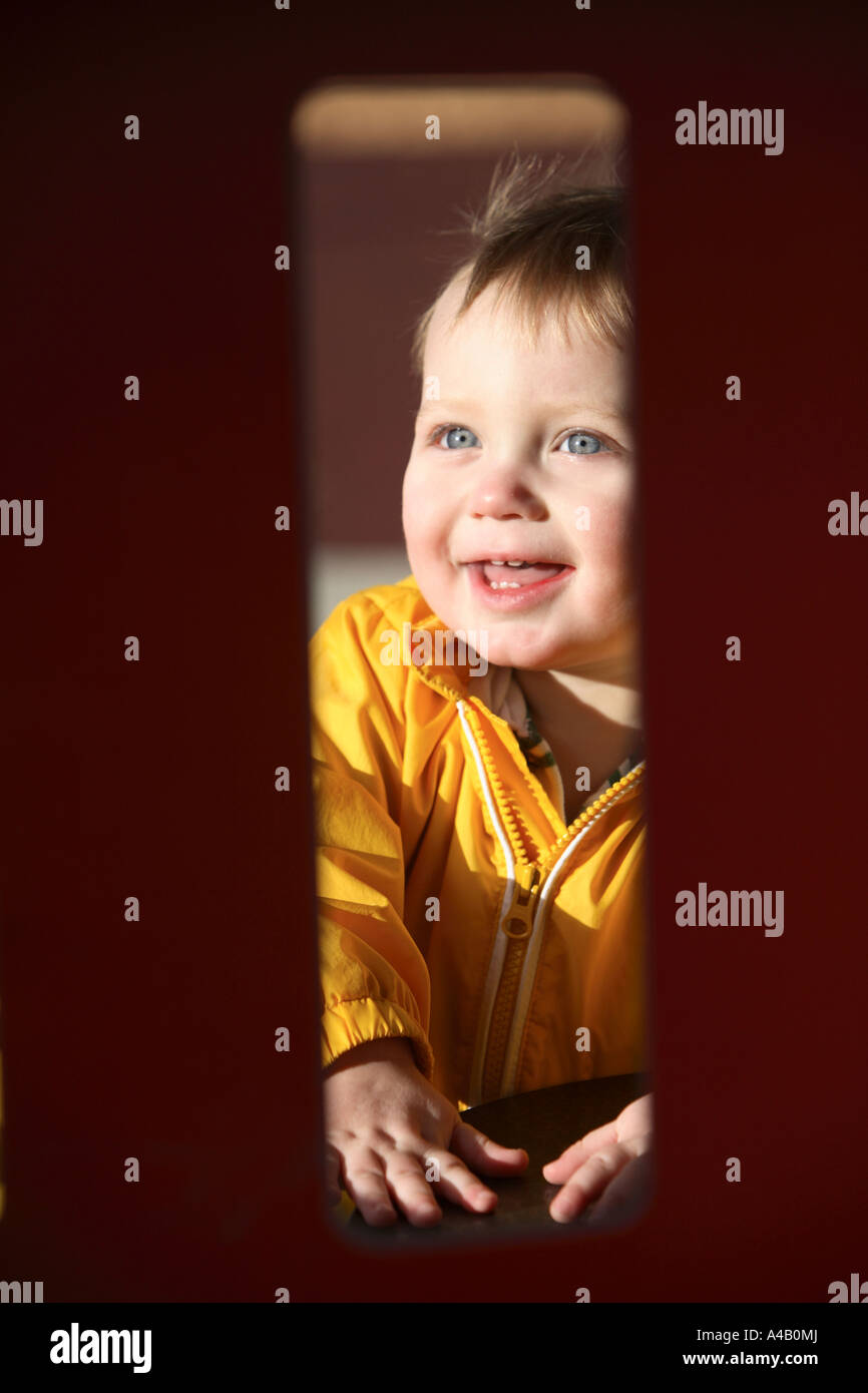 One year old boy photographed through a rectangle hole at a park Stock ...