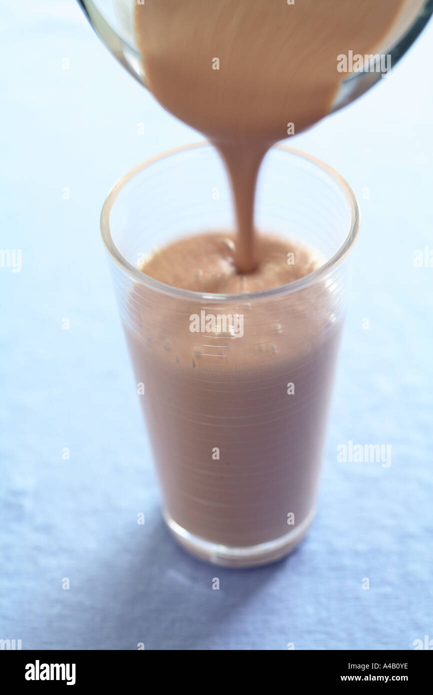 Pouring a chocolate milkshake Stock Photo - Alamy