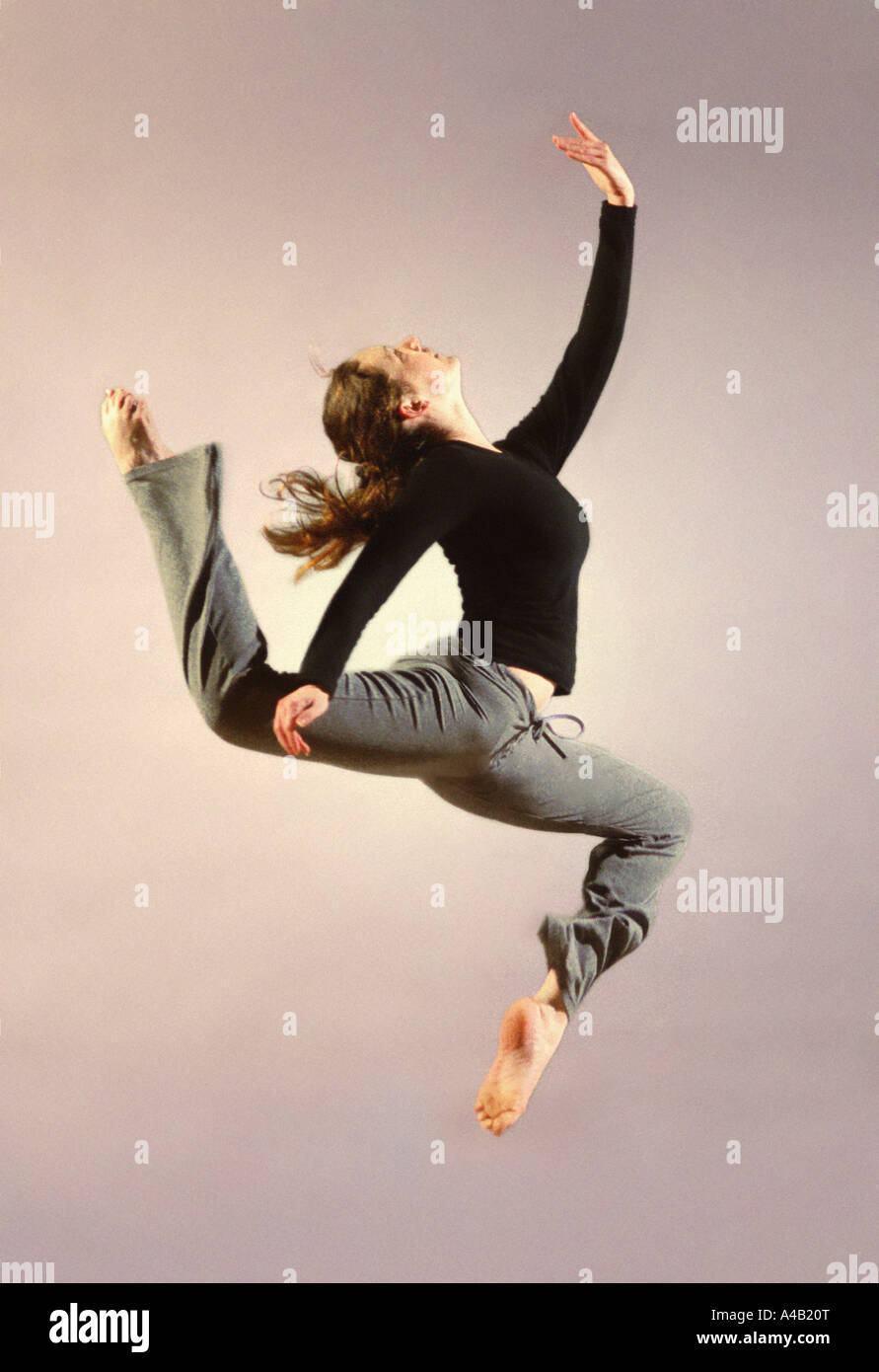 female dancer jumping with hand raised Stock Photo - Alamy
