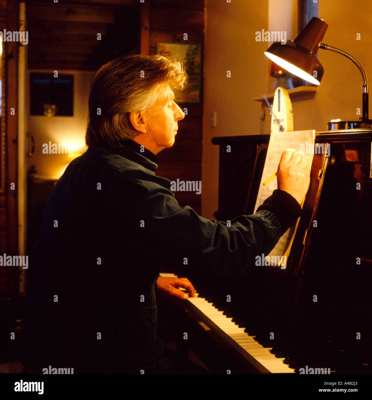 musical composer working at his piano writing a score Stock Photo - Alamy