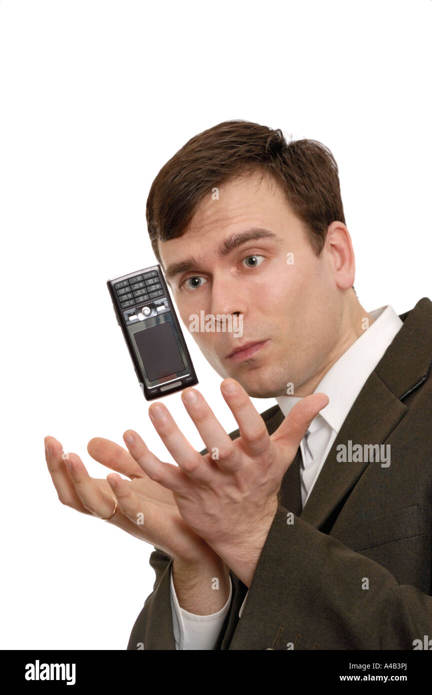 Businessman trying to catch a cell phone Stock Photo - Alamy