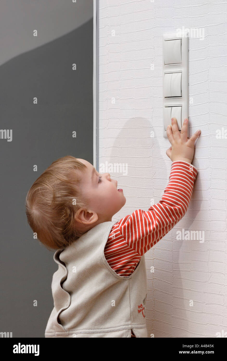 Child switching light off hi-res stock photography and images - Alamy