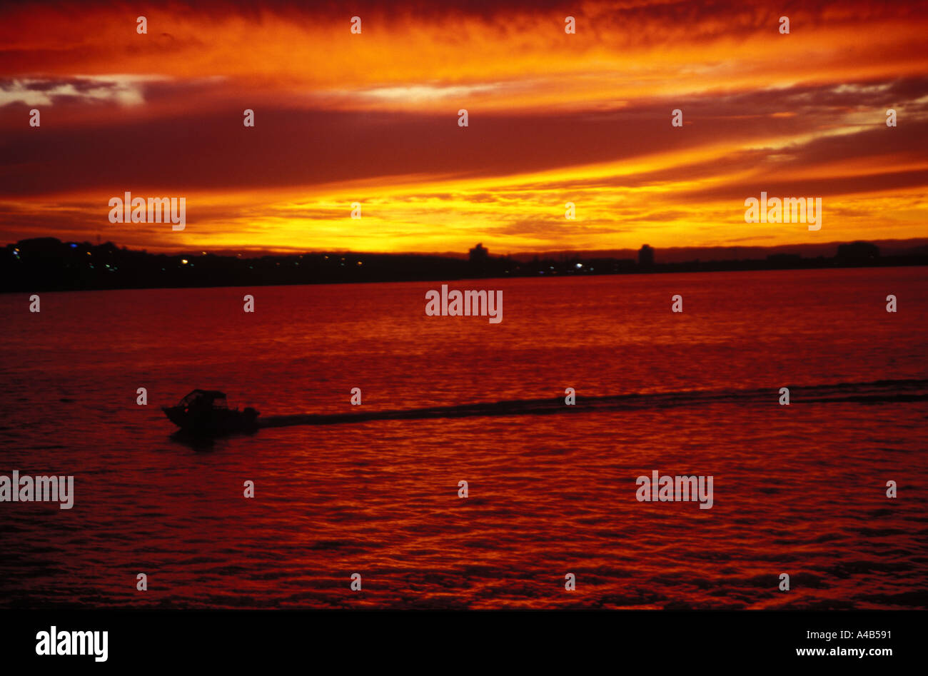 sunset over water Stock Photo - Alamy