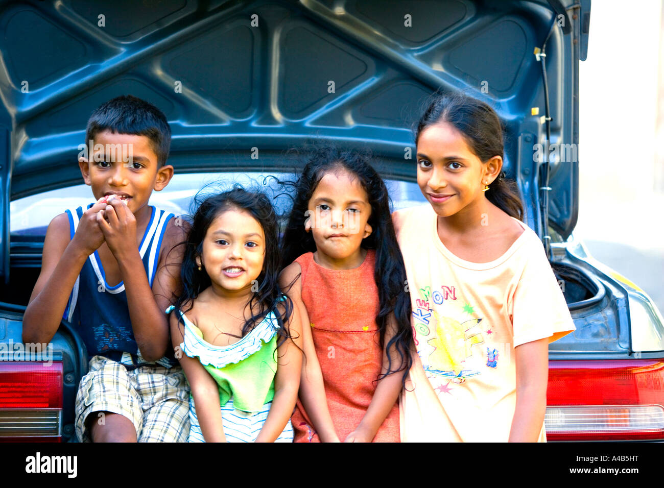 Young Mauritian children resting on car boot in "Rose Hill", "Mauritius ...