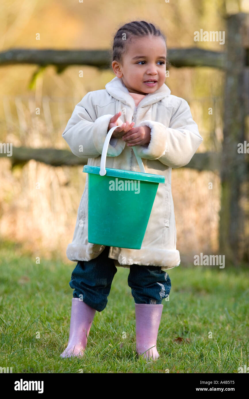 Girl carrying bucket in garden hi-res stock photography and images - Alamy