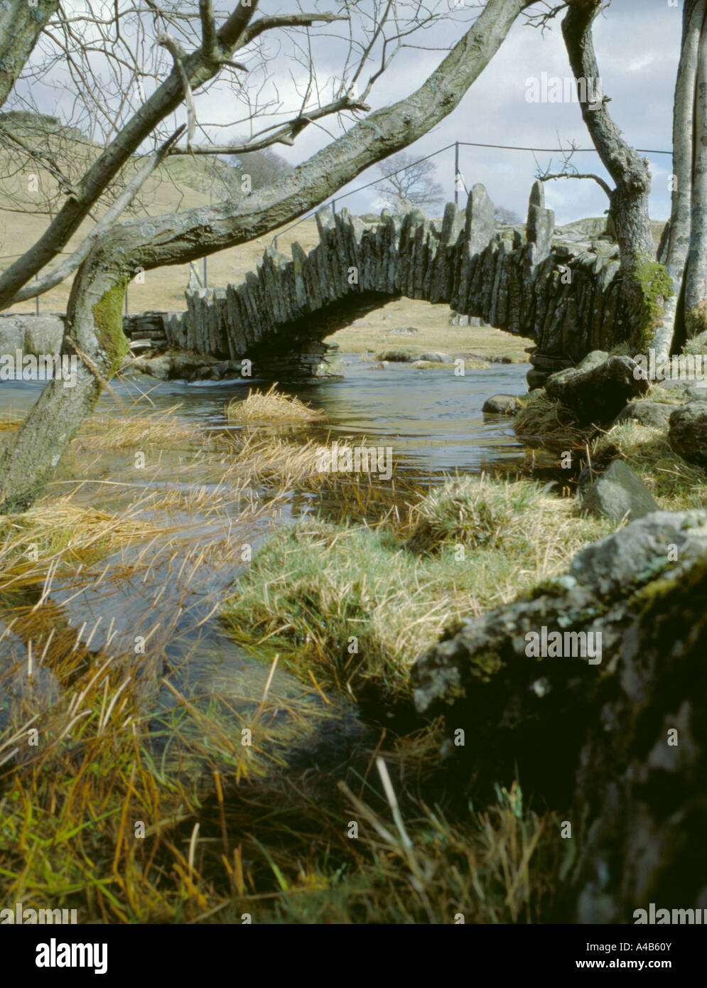 Simple stone arch bridge; Slater's Bridge over the River Brathay, near ...