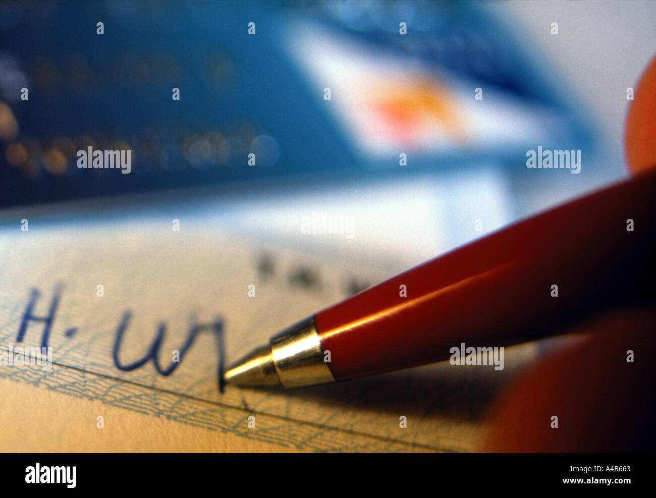 signing bank cheque check with credit bank card in background Stock ...