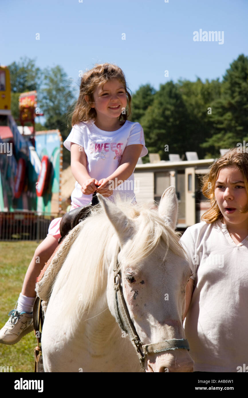Little girl riding a pony Stock Photo - Alamy